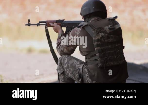 Unloading machine gun, soldier lying with gun, Army war concept, ready ...