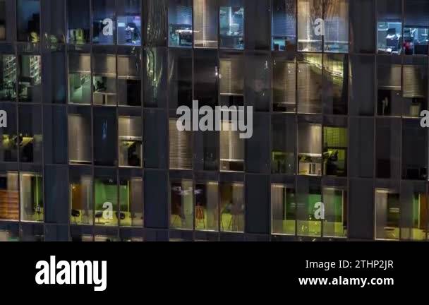 Night aerial view of office building glass panoramic window facade with ...