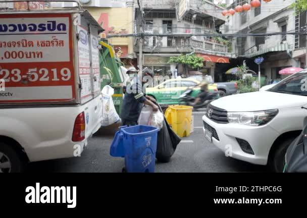 Waste Collector Collecting The Garbage On Trash Bin In The Street Of Chinatown In Bangkok ...