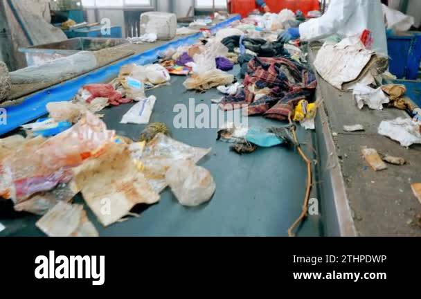 Workers in special wear sorting garbage on a conveyor belt at waste sorting plant Stock Video ...