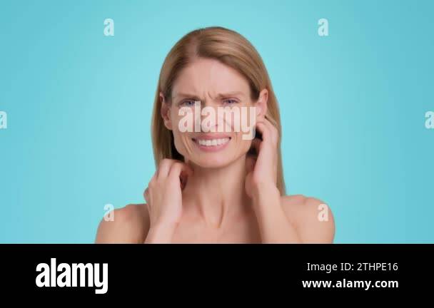 Allergy symptoms. Upset middle aged woman having rash, scratching her ...