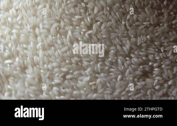 Dry Uncooked White Rice Background Rotating Left - Top View. Scattered ...