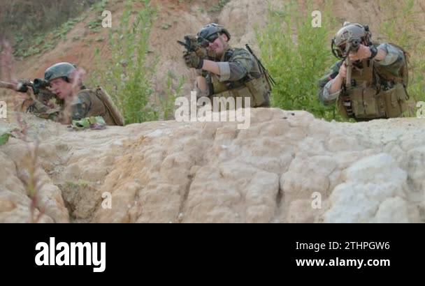 confident group of soldiers holding kneeling position aiming machine ...