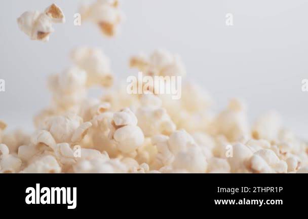 Mixing fresh hot popcorn. Close-up of popcorn production in slow motion ...