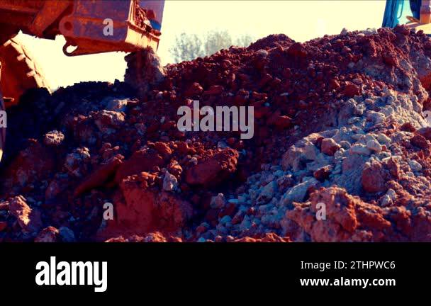 Large clay stones are dropped in a large pile. Stones are crumbling ...