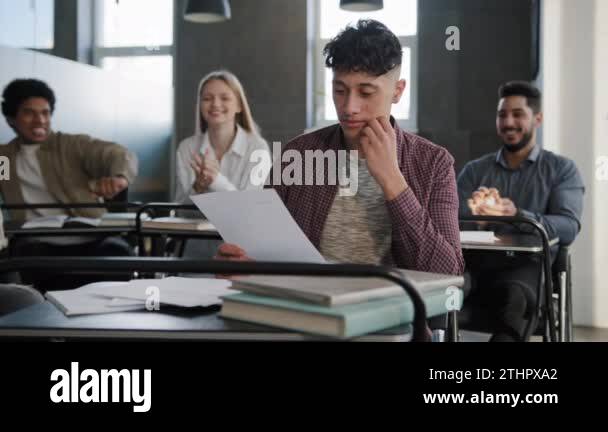 Sad upset abused depressed student sits in classroom at desk alone ...