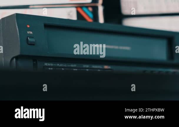 Insert VHS cassette into VCR player. Black vintage videotape cassette ...