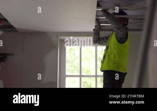 Hard male work on construction site. Two professional workers in ...