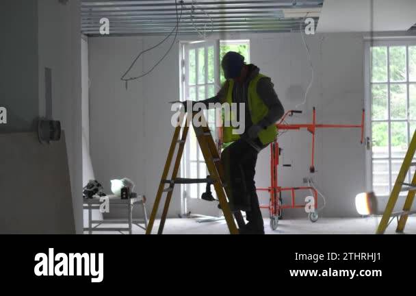 Hard male work on construction site. Two professional workers in ...
