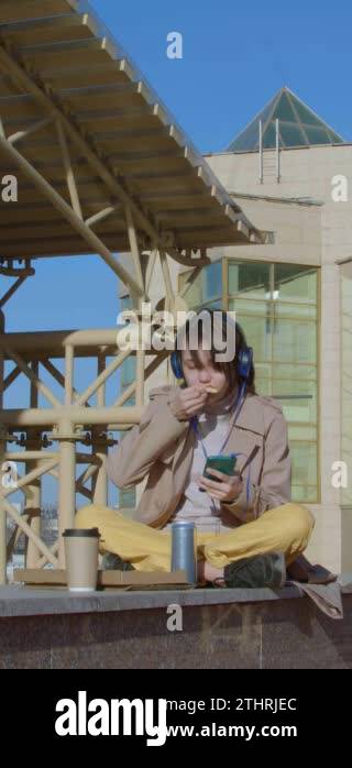 Teenage girl eating pizza outdoors. Youth addiction to junk food and ...