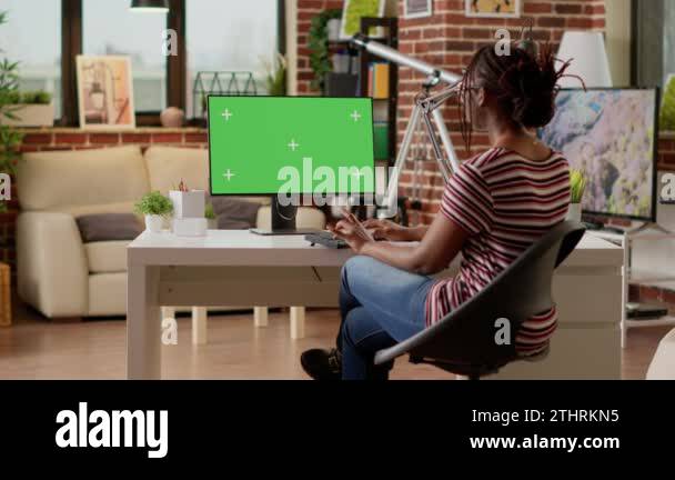 Company employee using greenscreen on computer and doing remote work ...