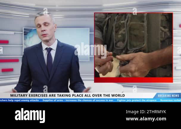 Male TV presenter reporting military news from TV studio in live news ...