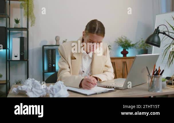 Angry furious woman working at home office throwing crumpled paper ...