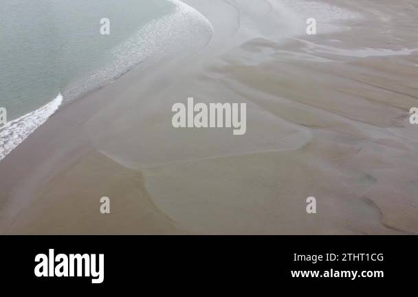Wet coastal sand, aerial view. Tidal waves and a sandy beach. Beautiful ...