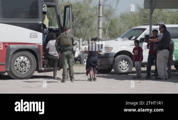 A US Border Patrol Agent and a DHS contractor supervise recently ...