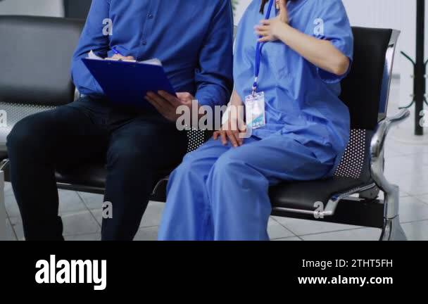 Assistant explaining medication treatment to senior patient during ...