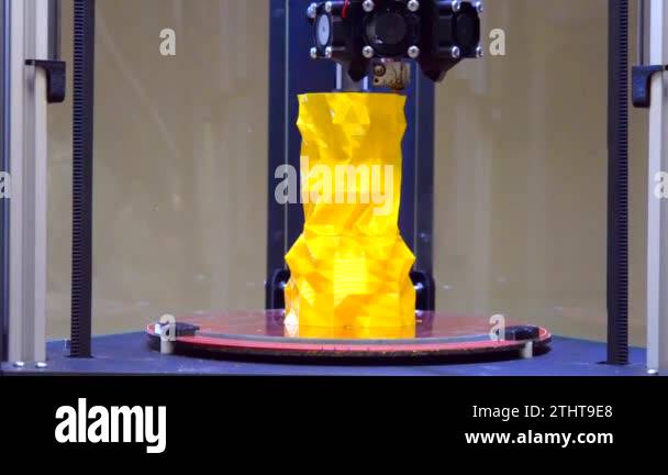 3d printing printer bright yellow model close-up. Automatic 3D printer ...