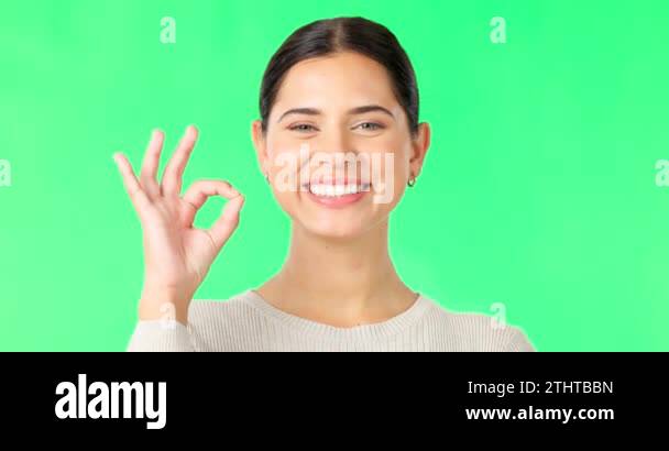 Face, green screen and woman with ok sign, smile and approval against a ...