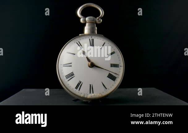 Silver vintage pocket watch with hands running in a circle in timelapse ...