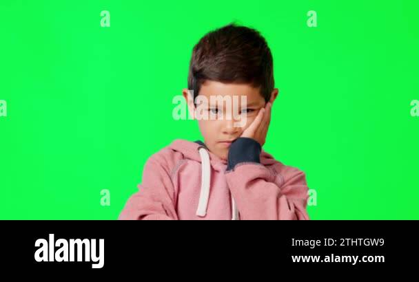Moody, face and child in a studio with green screen with a upset, bad ...