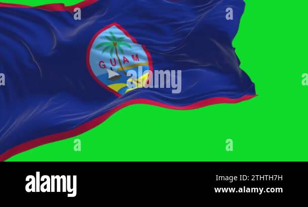 Flag of Guam waving in the wind isolated on a green background. Guam is ...