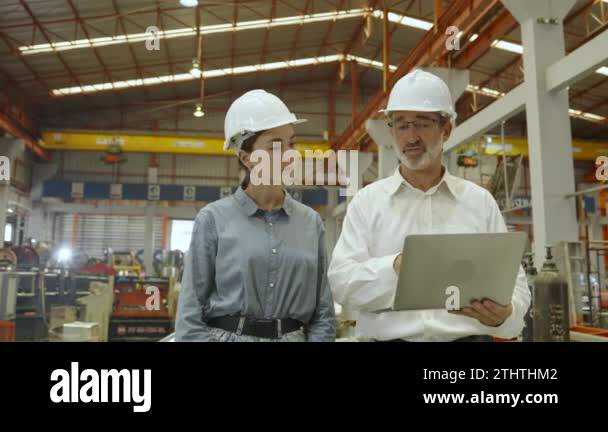 Heavy Industry Engineers women and men wearing safety helmets.Walk to ...