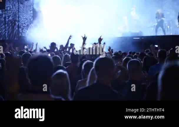 People silhouettes jump waving and clapping hands, crazy dancing with ...