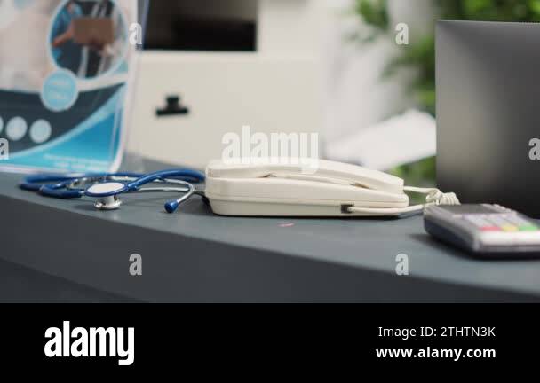 Facility counter with landline phone used to register checkup visit ...