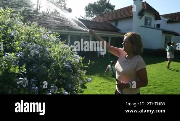 Woman watering beautiful house Stock Videos & Footage - HD and 4K Video ...