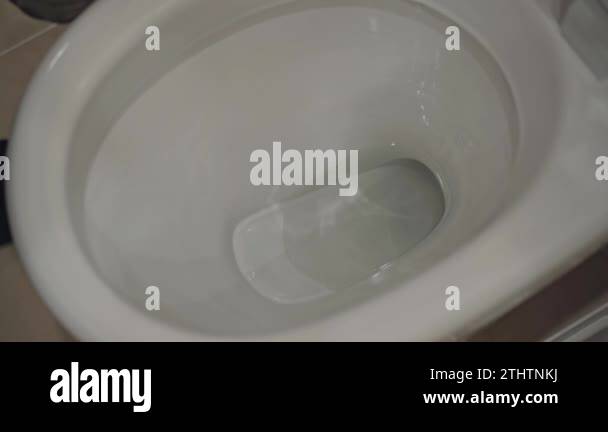 Man peeing in toilet in bathroom. First person point of view. Domestic ...