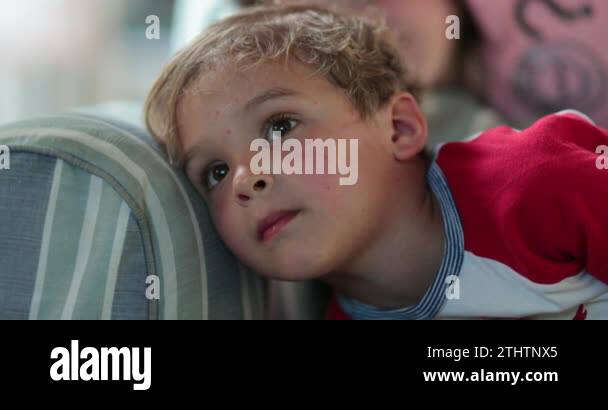 Toddler child staring at TV screen hypnotized. Boy watching screen on ...