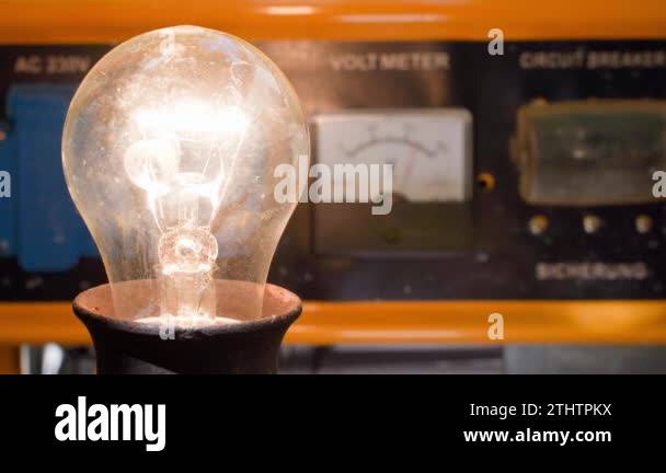 A flickering light bulb in the background of a working gas generator ...