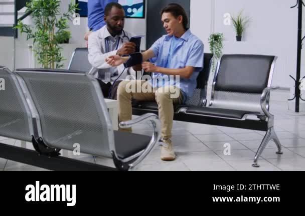African american general practitioner taking arterial tension to young ...