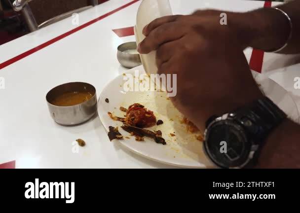 Man serving chicken biriyani into his plate. The most popular Indian ...