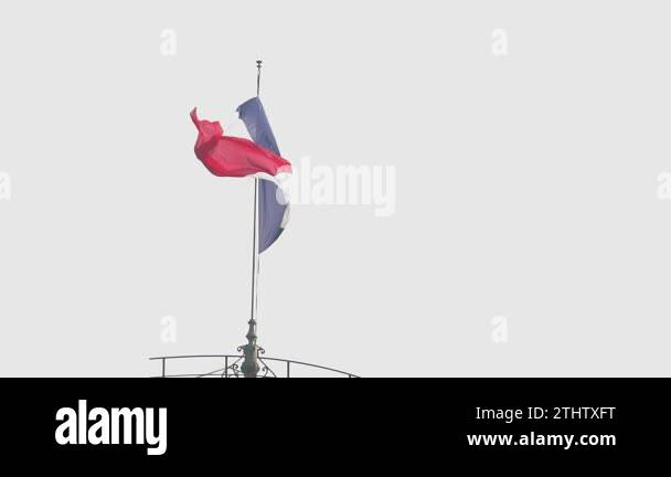 Beautiful French flag hanging on top of building, waving in wind, slow ...