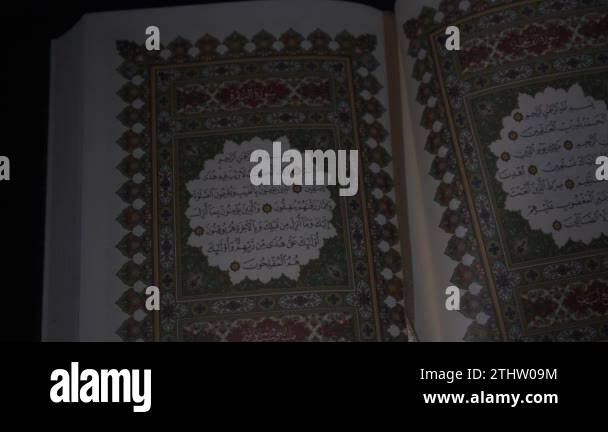 Closing the Muslim holy book. Cover of the book with gold lettering ...