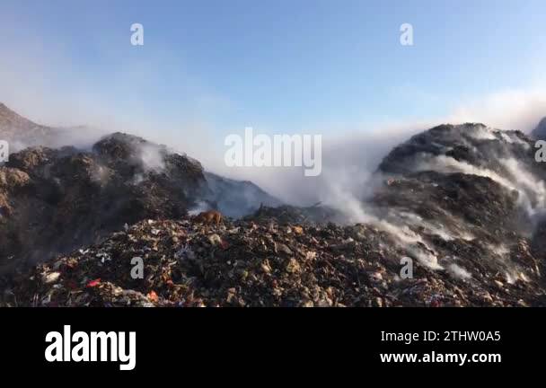 Burning pile of garbage at dump ground or landfill releasing toxic ...