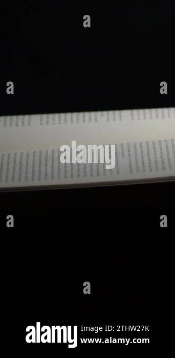 Pages of open book with black background, rotation. 4K Vertical Stock ...
