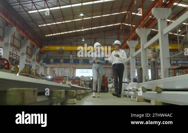 Heavy Industry Engineers women and men wearing safety helmets.Walk to ...