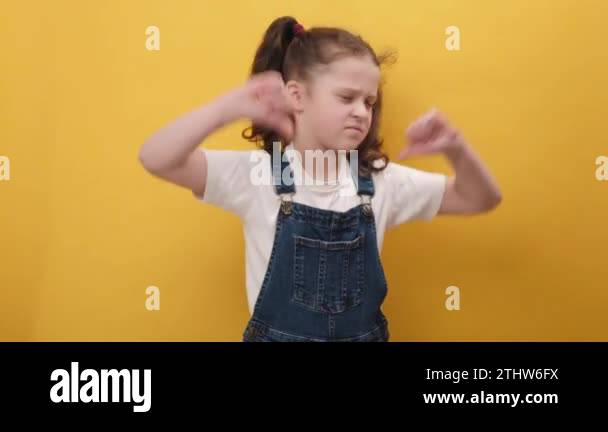 Dislike concept. Upset preteen girl kid showing thumbs down sign ...
