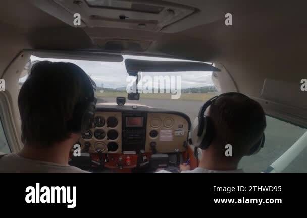 Flight Instructor Giving Instructions To Student Pilot In The Cockpit ...
