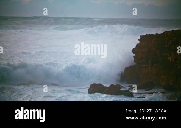 Dangerous waves hitting cliff in slow motion. Dramatic storm sea ...