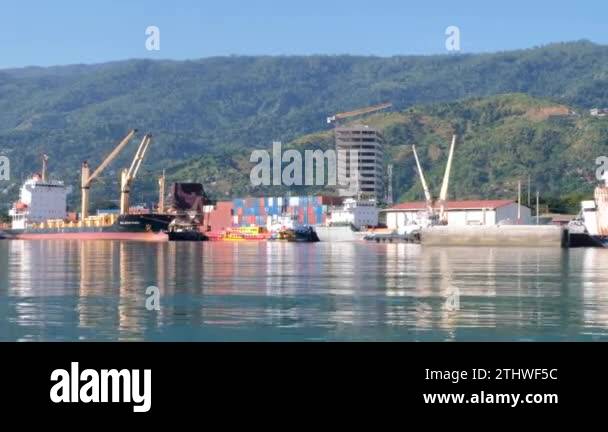A view of shipping containers, ships and industrial cranes at the dock ...