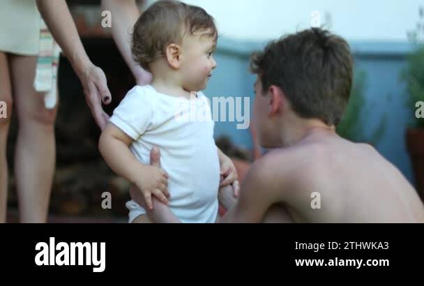 Candid older brother caring for baby sibling. Real life family moment ...