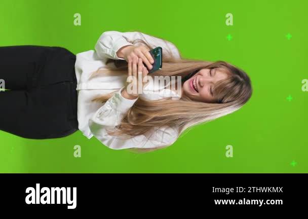 Side view of happy, glad woman standing, using smartphone, scrolling ...