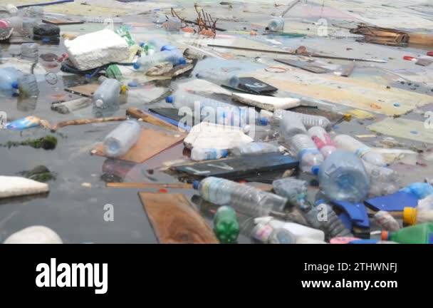 Environmental pollution. Plastic bottles, bags, trash in river, lake ...