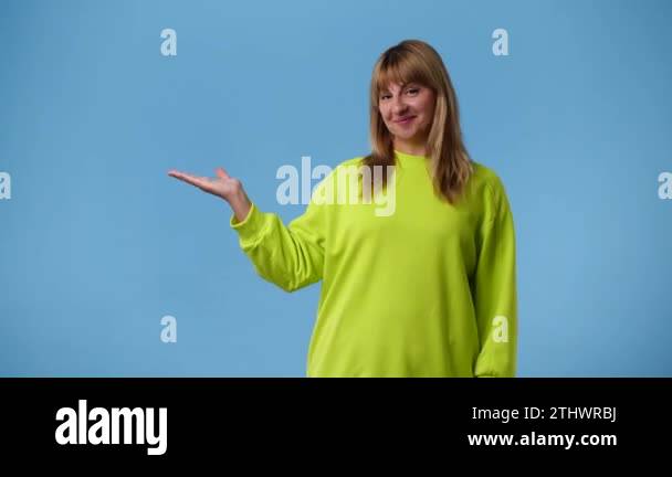 4k video of one woman who pointing his finger to the left and smiling ...