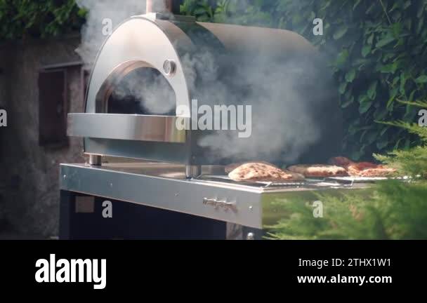 Traditional weekend cookout, firing up barbecue smoker for grilling ...