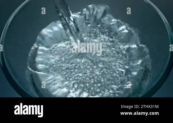Sparkling aqua pouring glass top view closeup. Transparent mineral ...