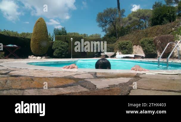 Static slow motion footage of young guy getting out of the swimming ...